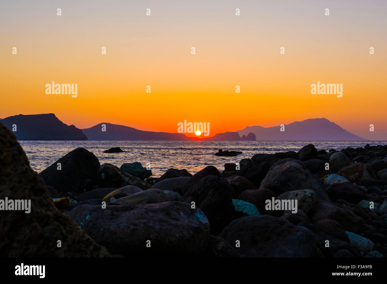 Beautiful sunset at a beach of Greek island of Milos Stock Photo - Alamy