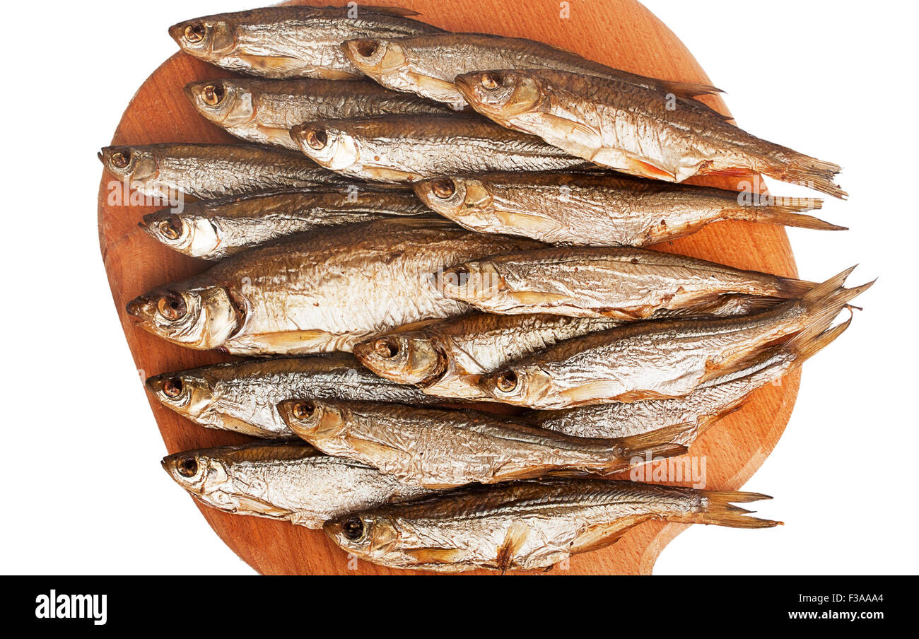 Many bloaters on a wooden board isolated on white background Stock ...