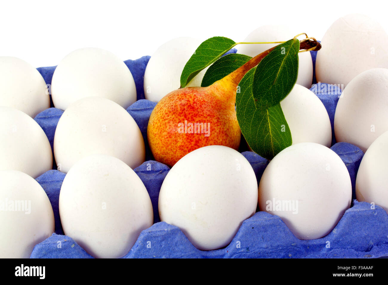 blue tray of white eggs with pear in center Stock Photo - Alamy