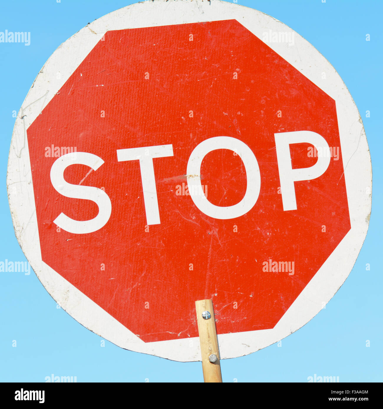 Stop sign on wooden stick - held by road construction workers to ...