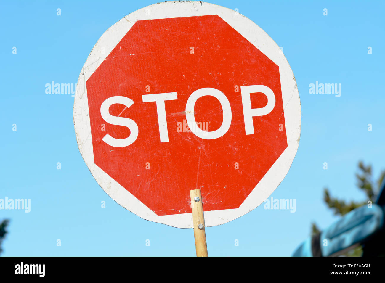 Stop sign on wooden stick - held by road construction workers to ...