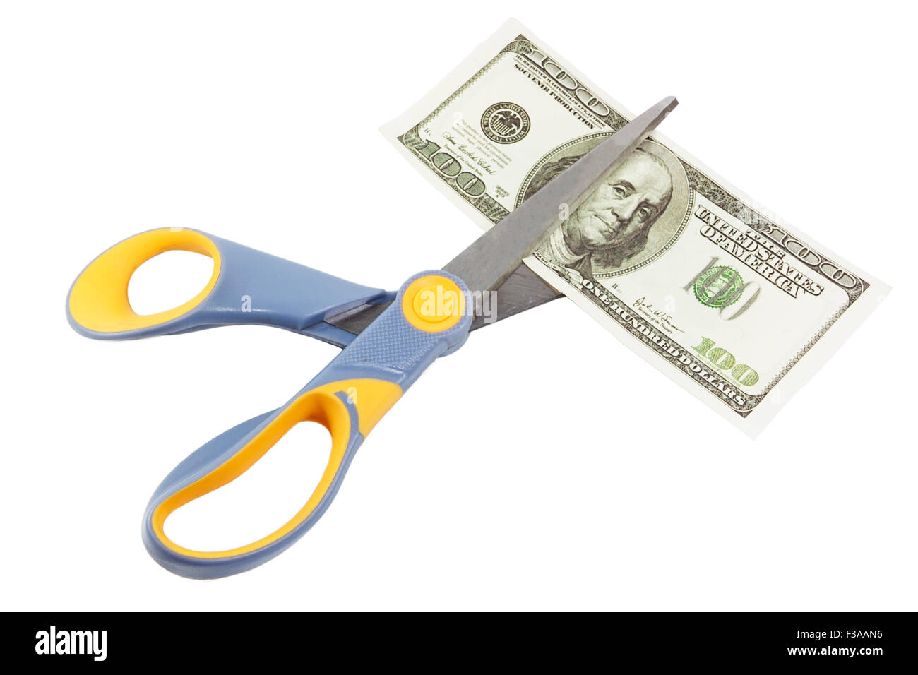 scissors cut a hundred dollar bill isolated on a white background Stock ...