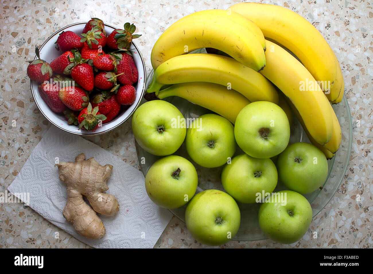 Still life of bananas, apples, strawberries and ginger Stock Photo - Alamy
