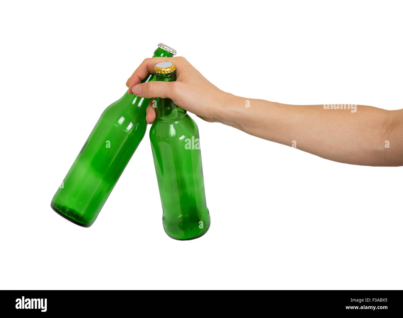 Two empty bottles of beer in a female hand isolated on white background ...
