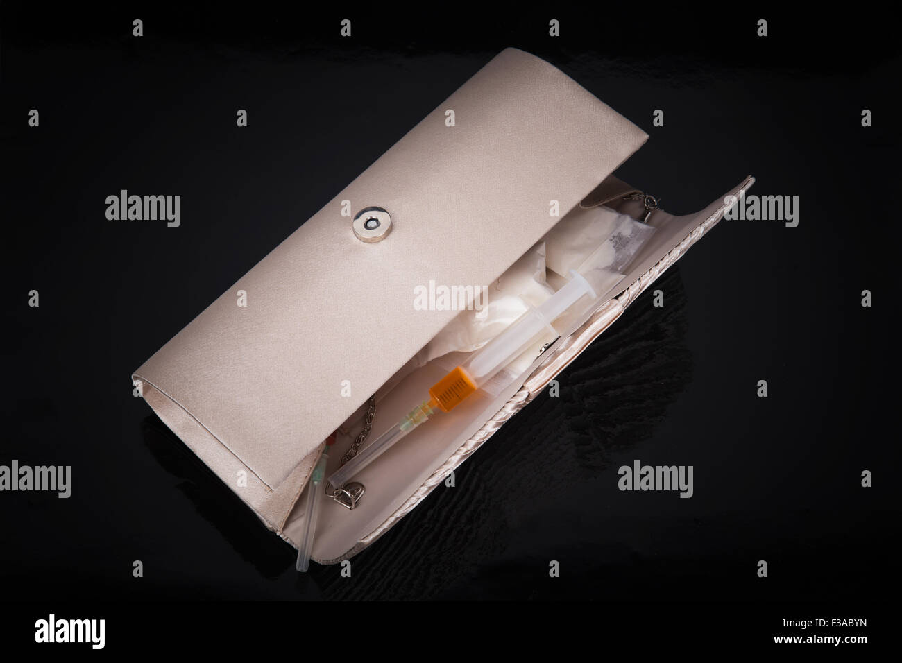 Drugs in the women's handbag isolated on a black background Stock Photo ...