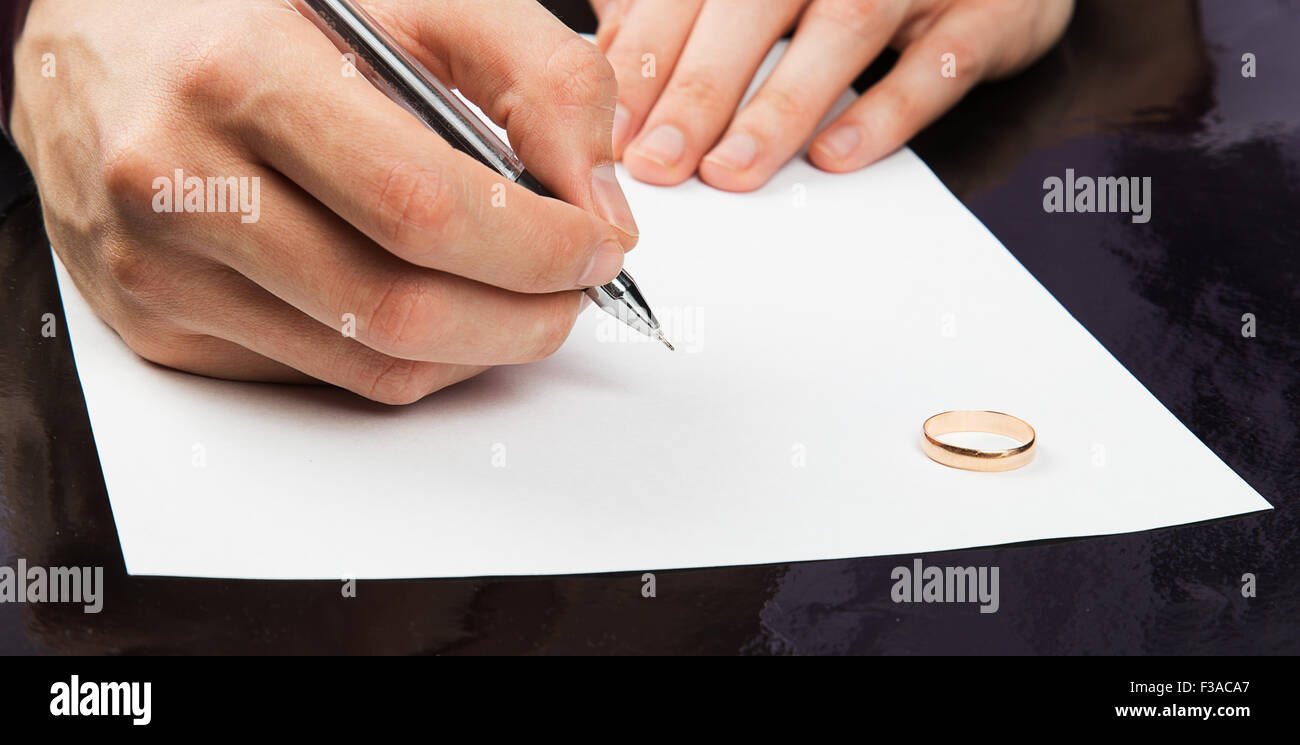 Closeup of male hand signing divorce papers Stock Photo - Alamy