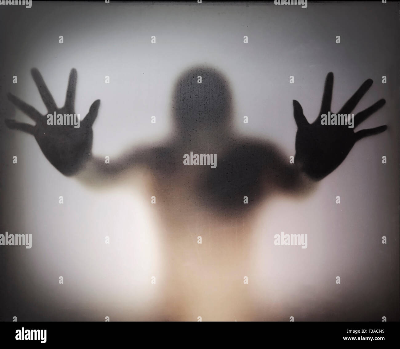Man standing behind frosted glass Stock Photo - Alamy