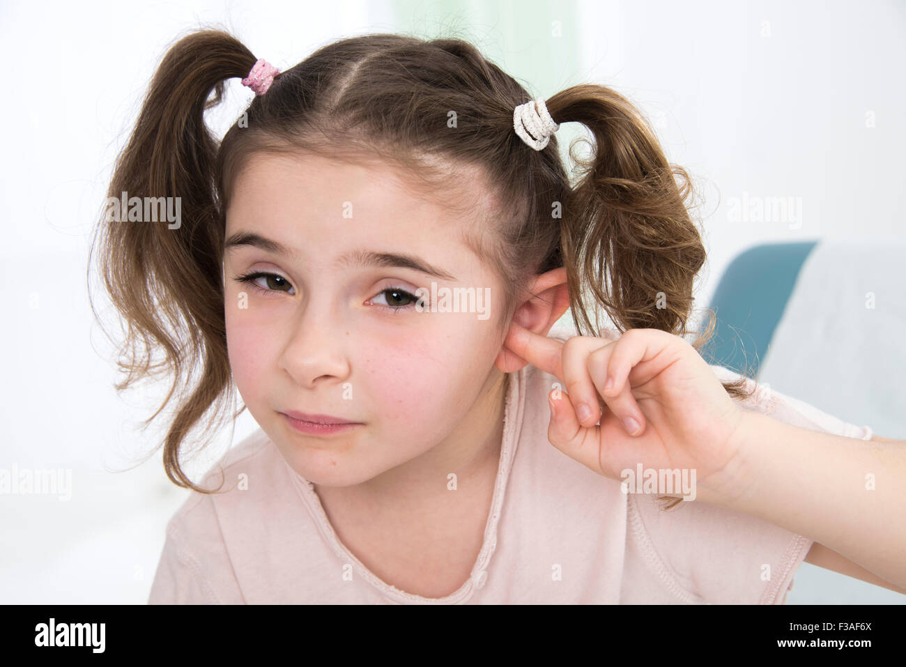 MODEL RELEASED. Young girl with her finger in her ears Stock Photo - Alamy