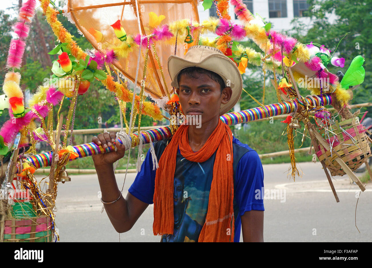 Indian boy carries a colorful kavadi cart during the Hindu festival ...