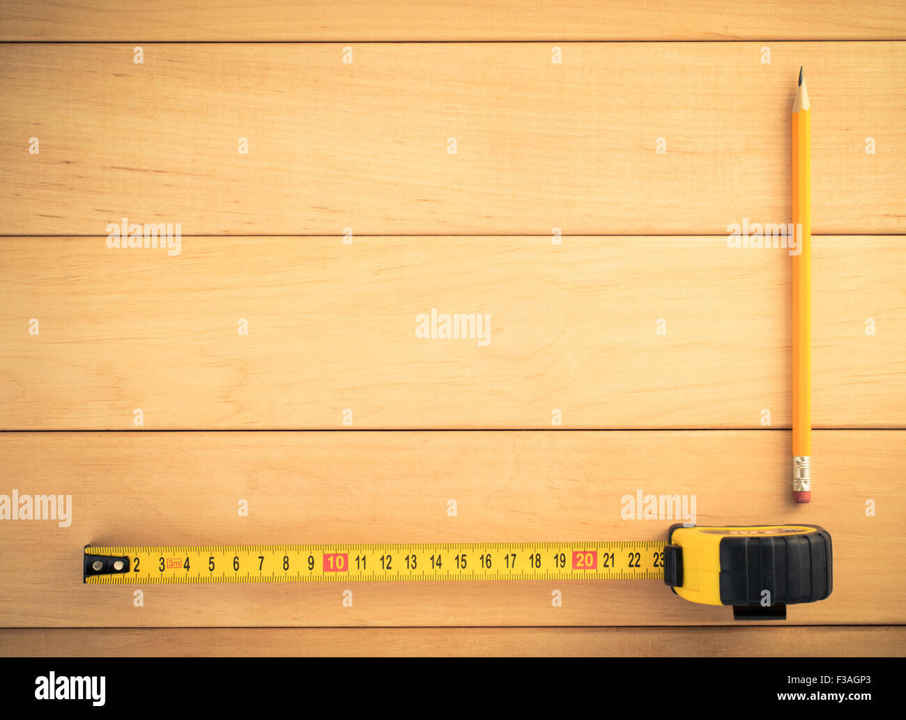 tape measure and pencil on wooden texture Stock Photo - Alamy