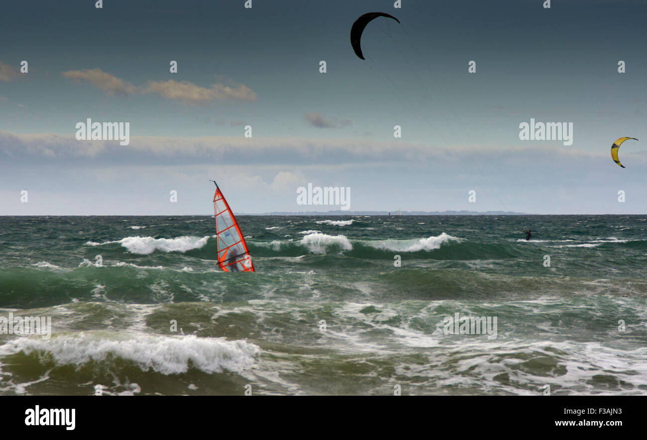 Kite surfing and windsurfer in surf close to beach Stock Photo - Alamy