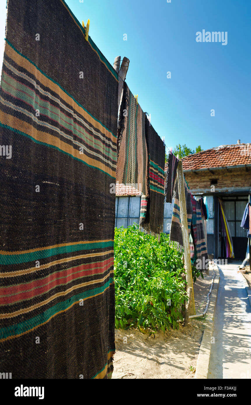 Cleaning and hand washing the rugs in the village Stock Photo - Alamy