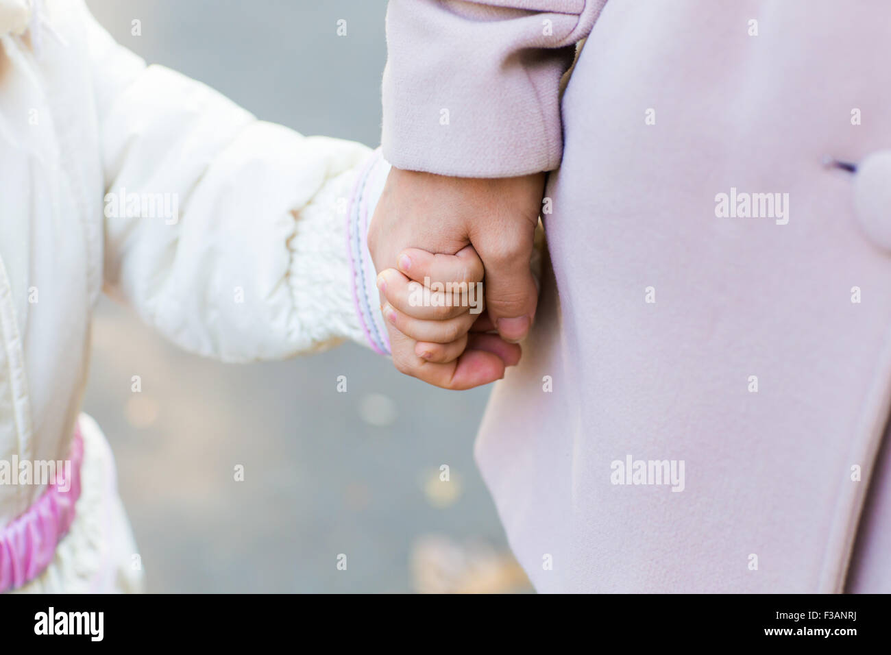 Mother holding baby hand Stock Photo - Alamy