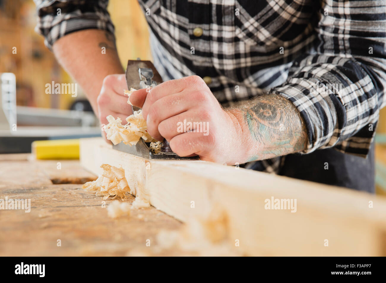 Carpenter work with plane on wood plank Stock Photo - Alamy