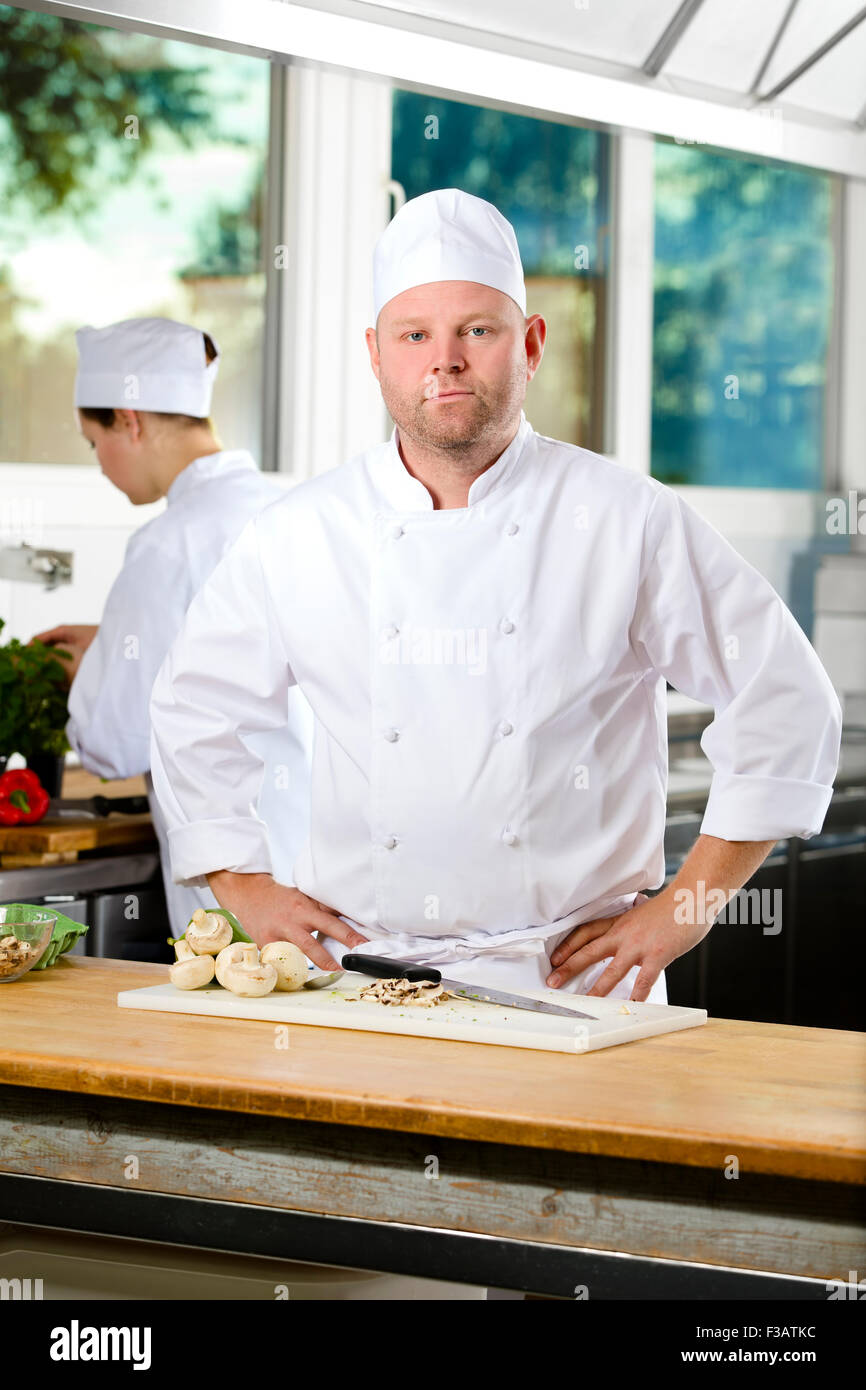 Confident chef standing in large kitchen Stock Photo - Alamy
