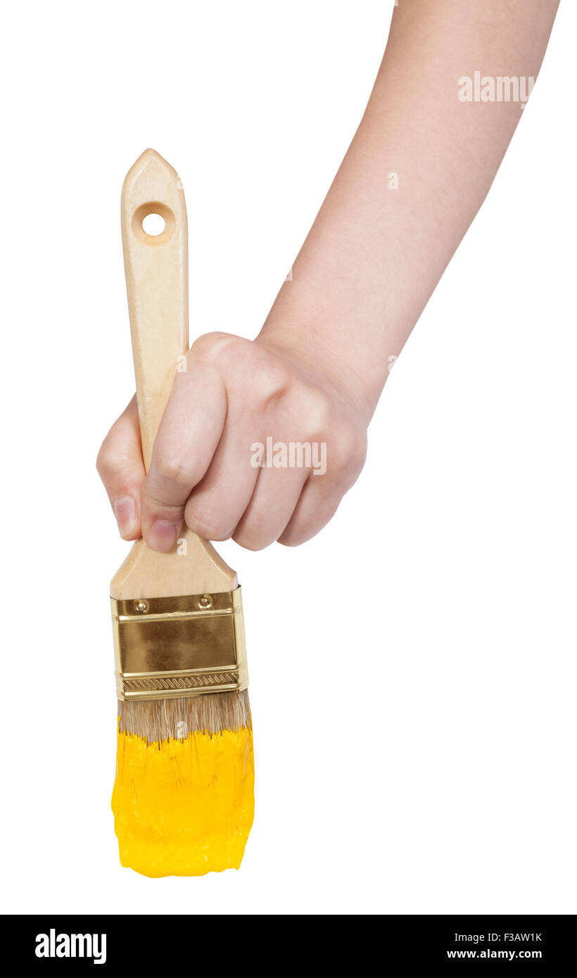 direct view of painter hand with flat paintbrush painting in yellow ...