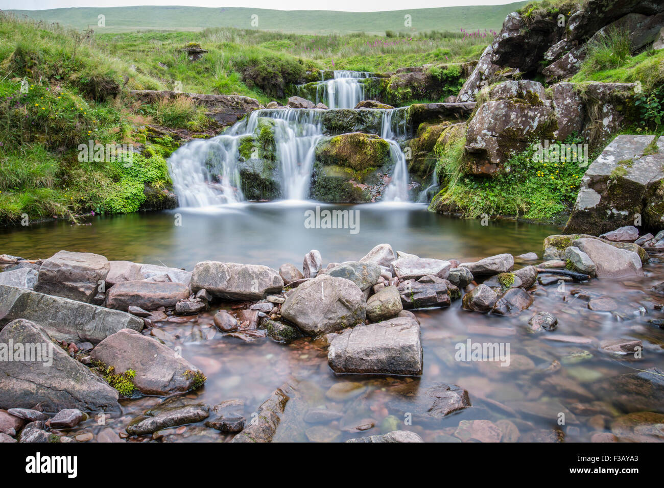 running water from the hills falling on rocks Stock Photo - Alamy