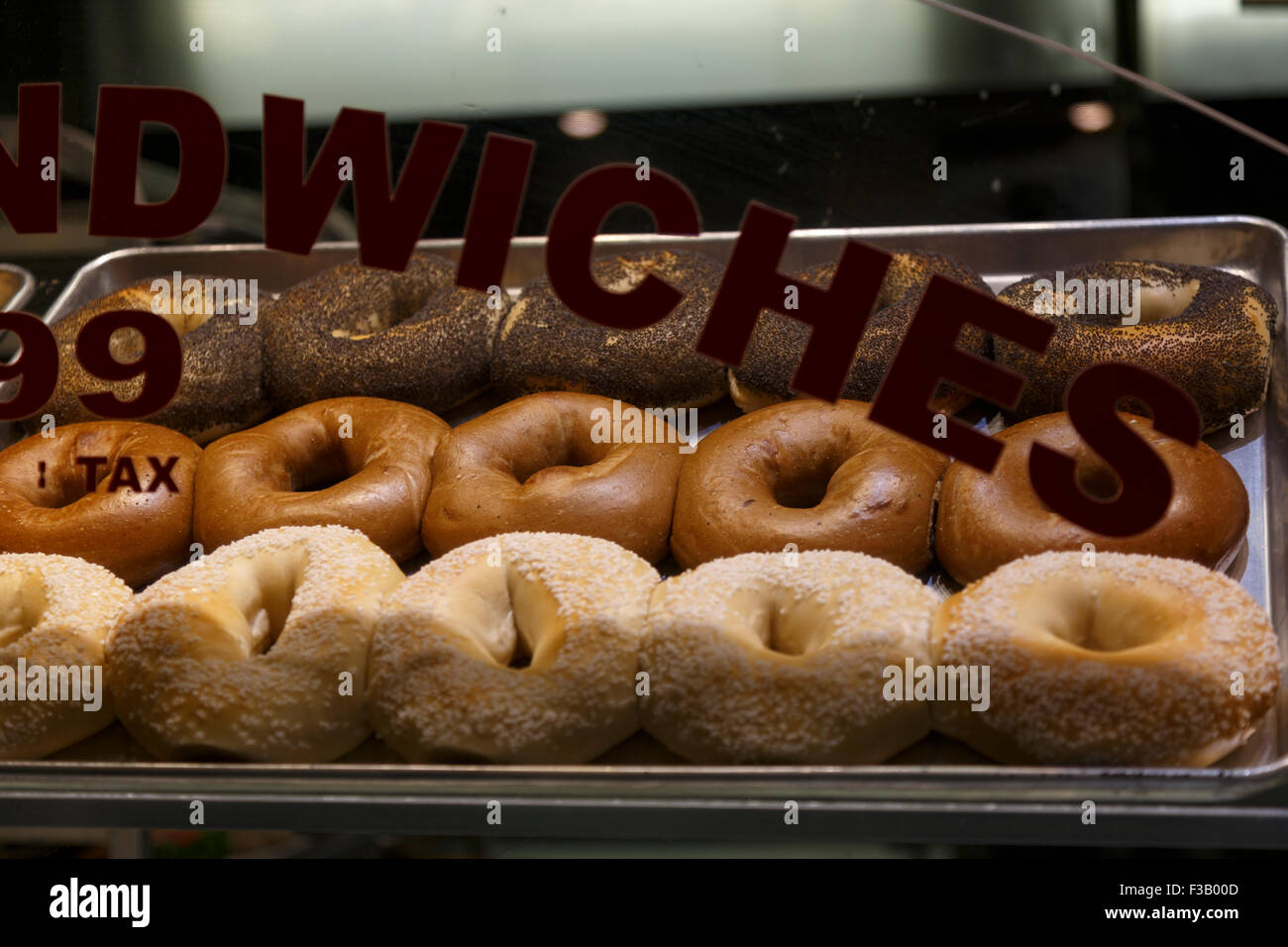 Tray of bagels seen through shop window Stock Photo - Alamy