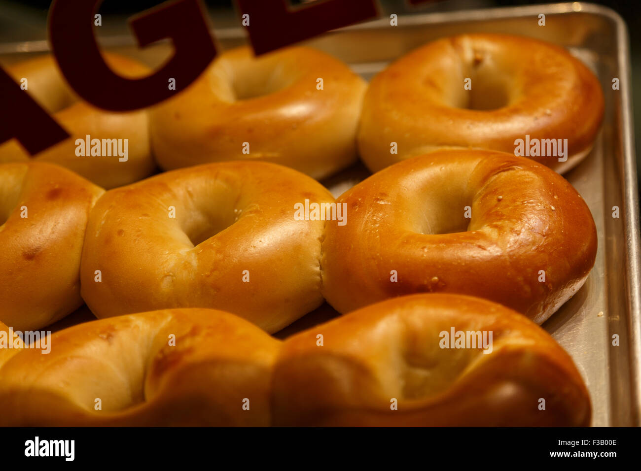 Tray of bagels seen through shop window Stock Photo - Alamy