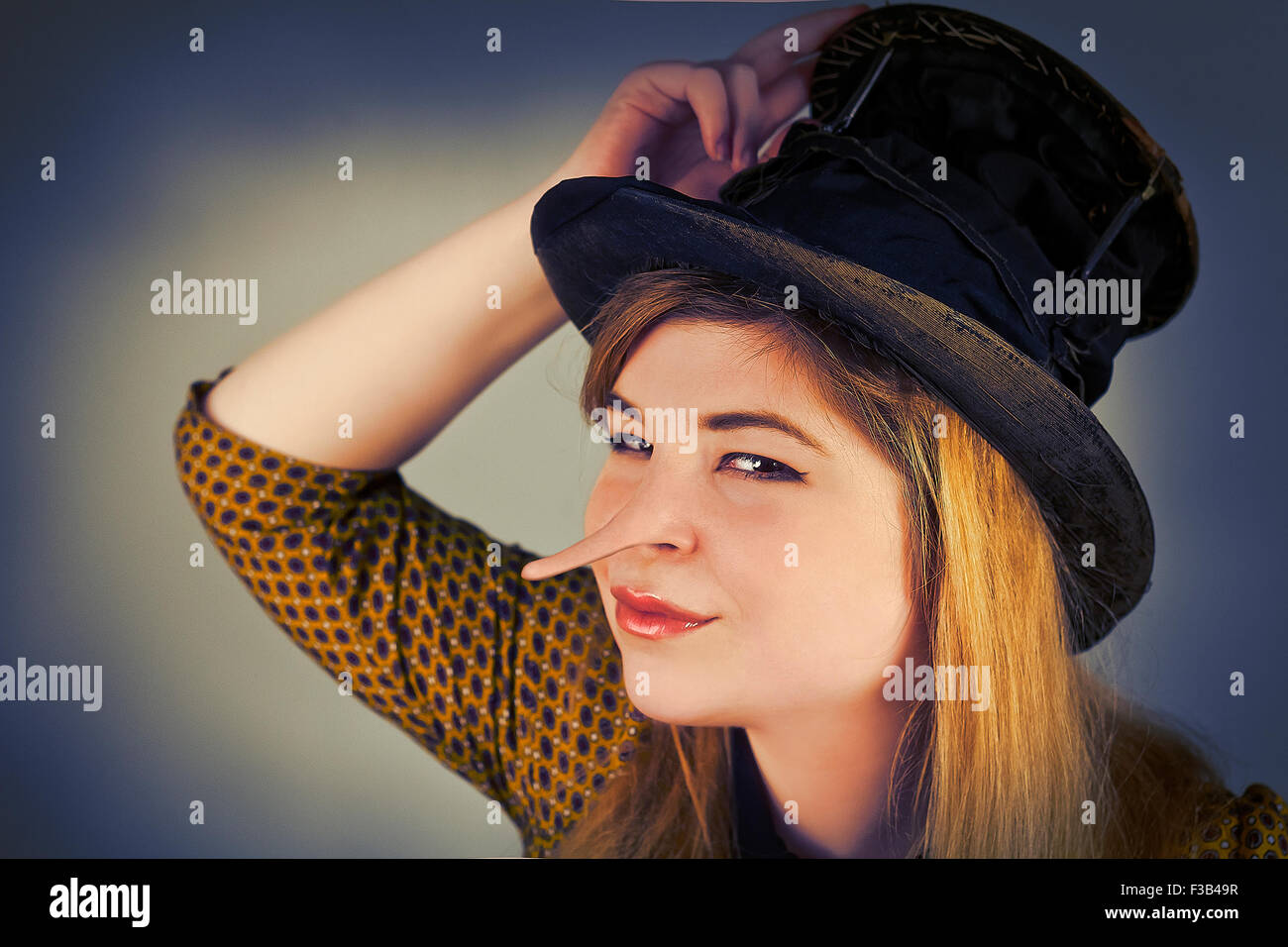 Lying tramp girl wears old top hat in vintage photo style Stock Photo ...