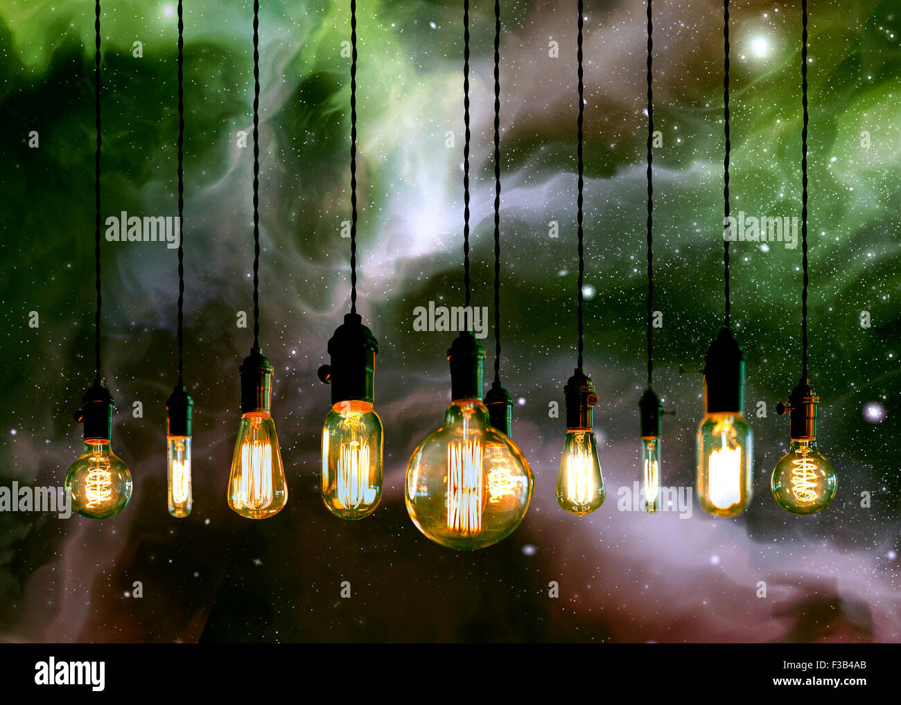 Edison style light bulbs against beautiful universe of stars and ...