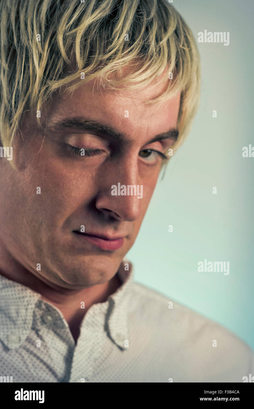 Blonde haired creepy strange man winks at the camera Stock Photo - Alamy