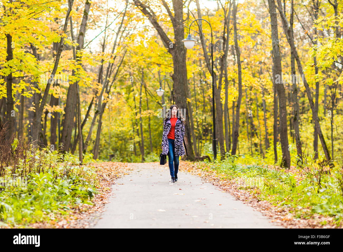 Woman walking happy in a park Stock Photo - Alamy
