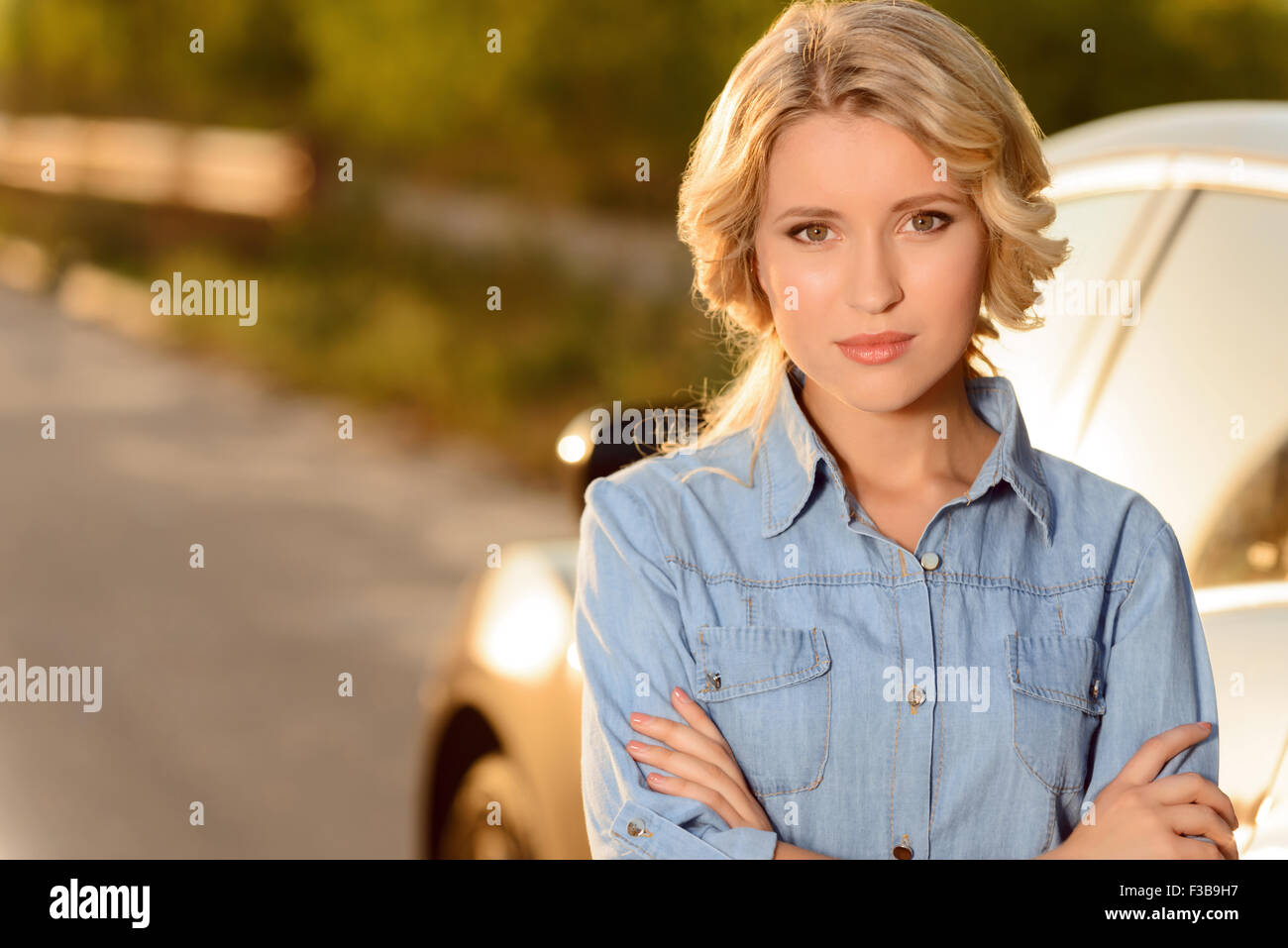 Attractive girl standing near car Stock Photo - Alamy