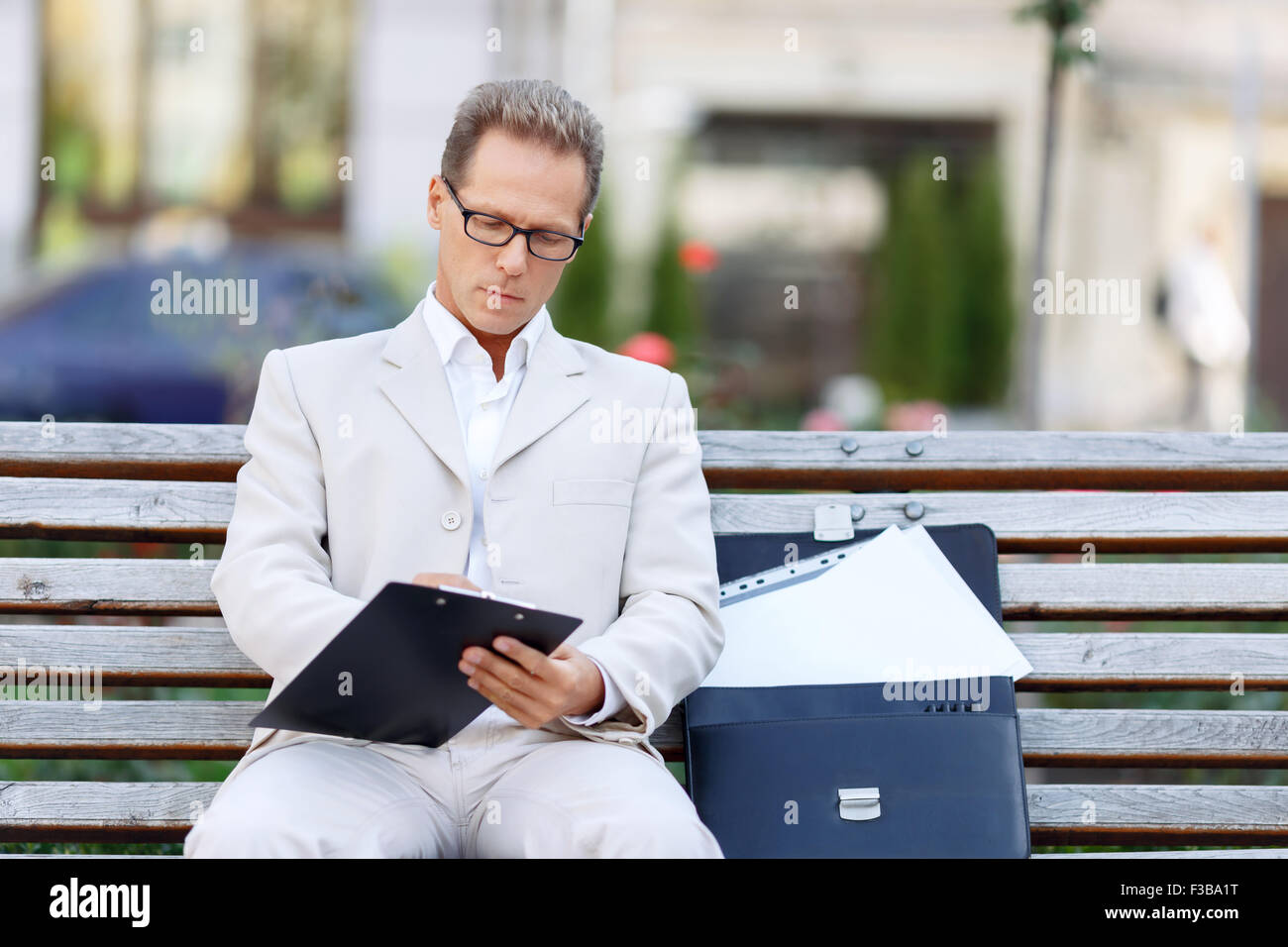 Handsome man sitting on the bench Stock Photo - Alamy