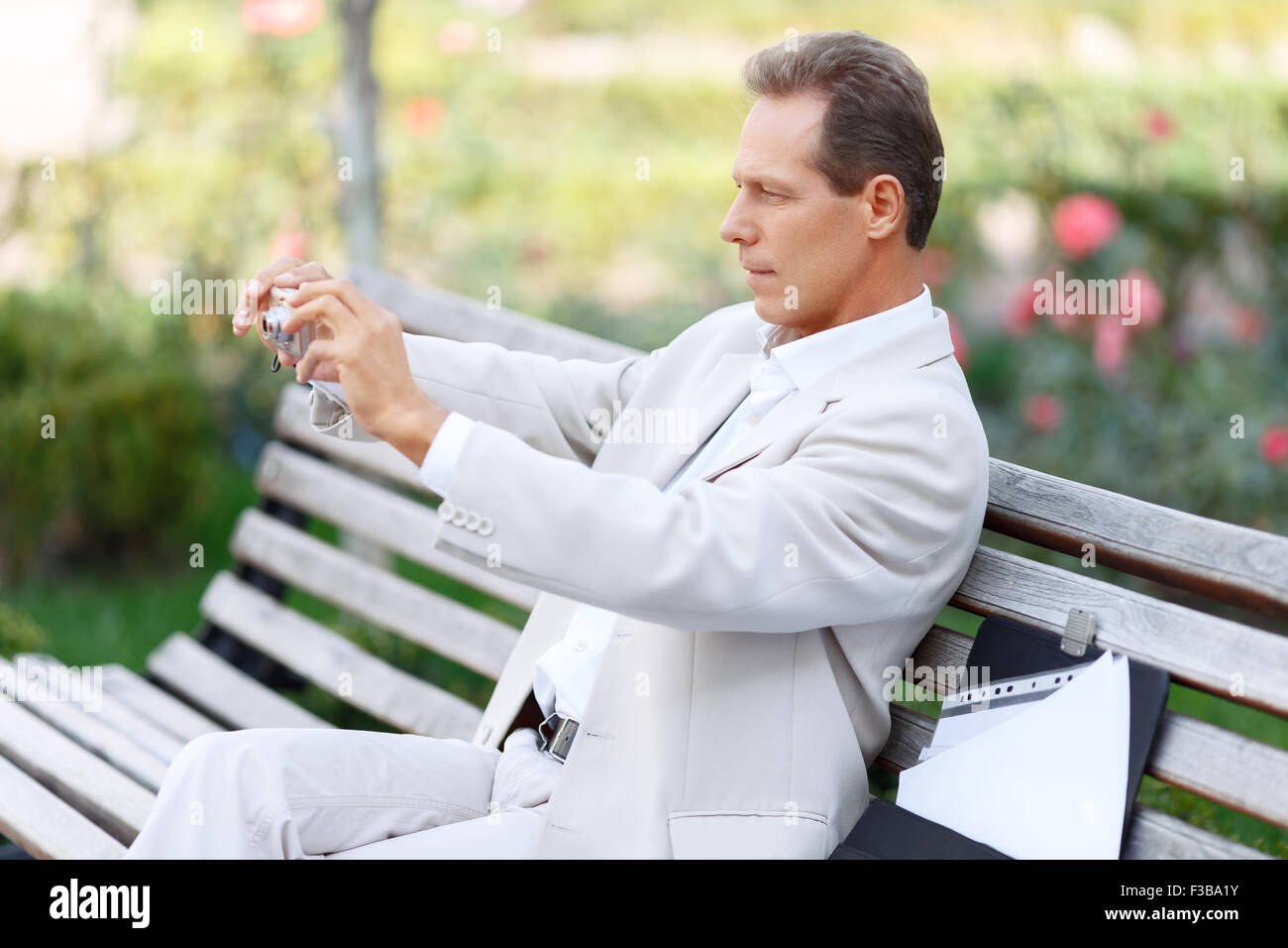 Handsome man sitting on the bench Stock Photo - Alamy
