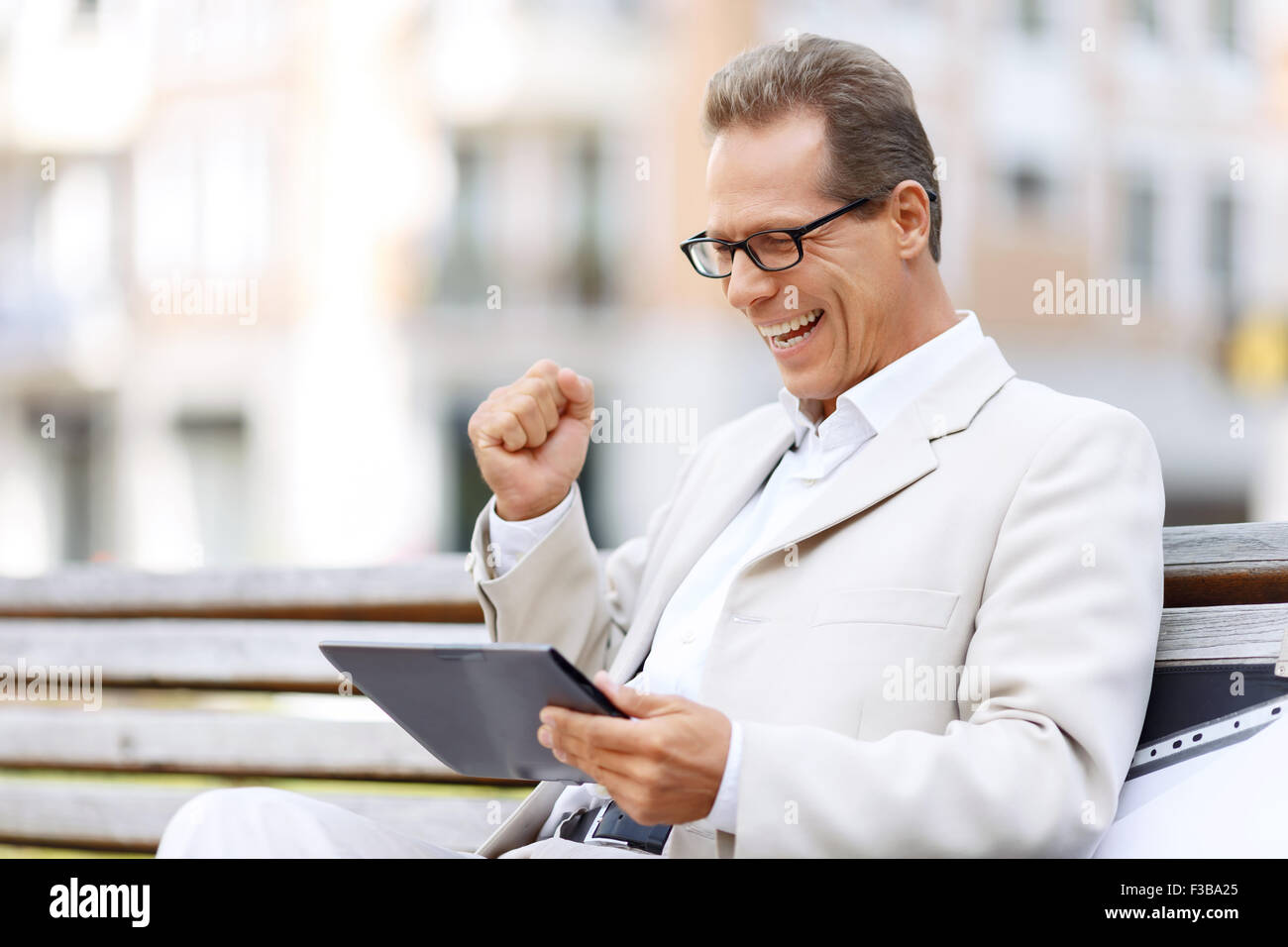 Handsome man sitting on the bench Stock Photo - Alamy