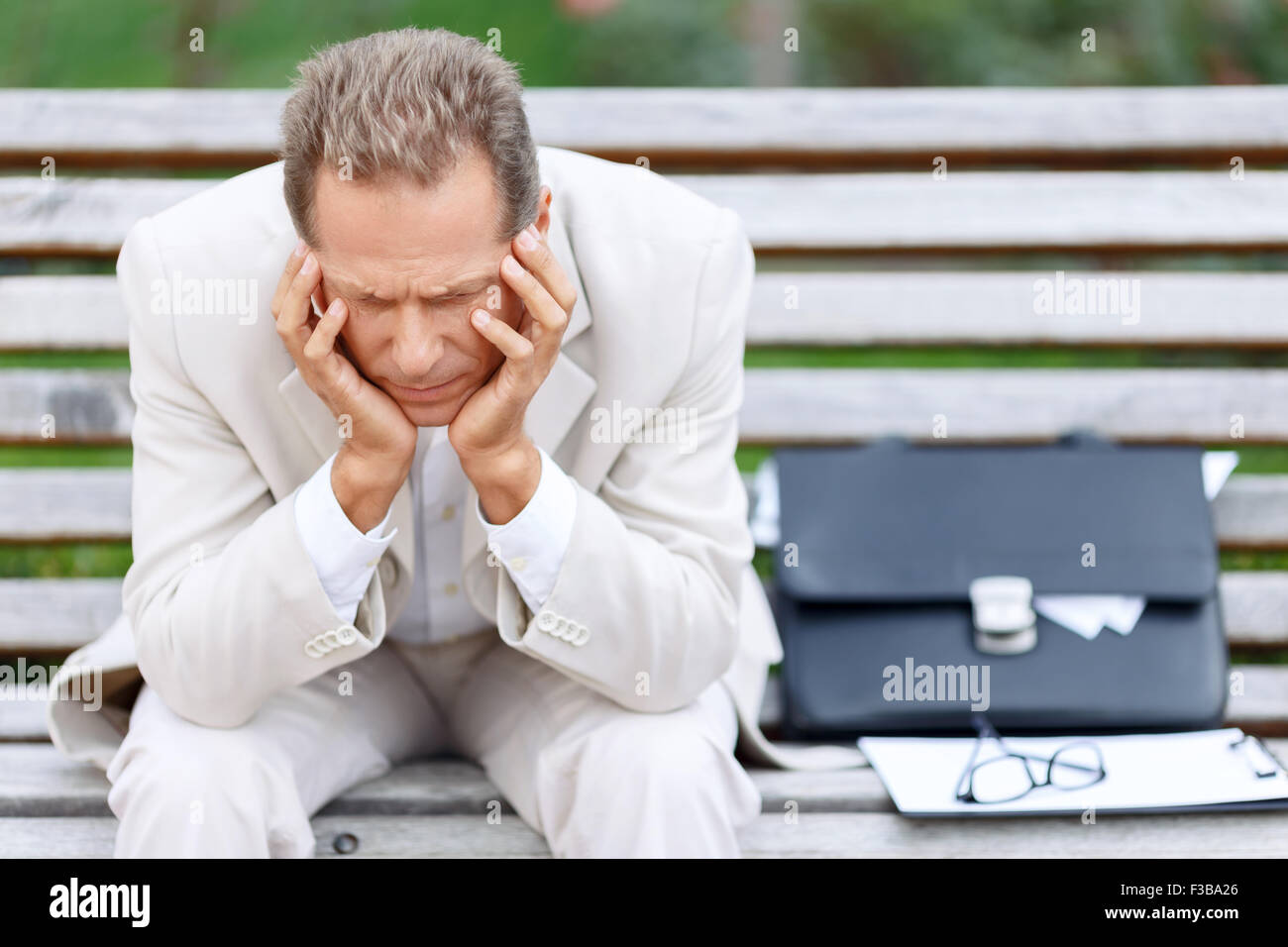 Handsome man sitting on the bench Stock Photo - Alamy