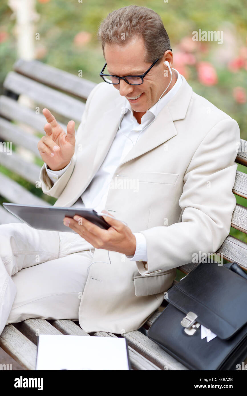 Handsome man sitting on the bench Stock Photo - Alamy