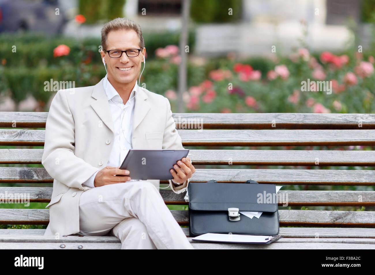 Handsome man sitting on the bench Stock Photo - Alamy