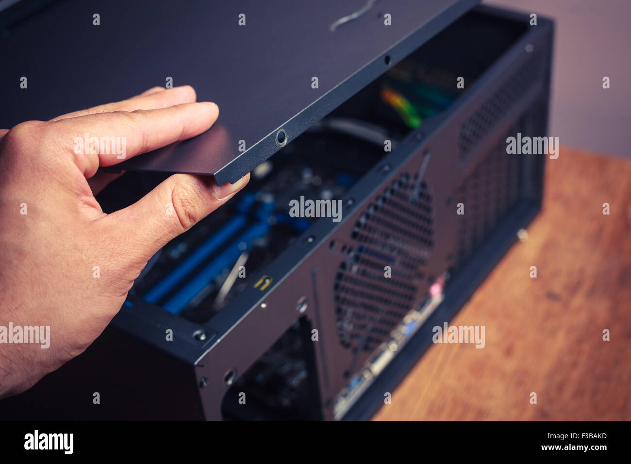 A hand is opening up a computer case Stock Photo - Alamy