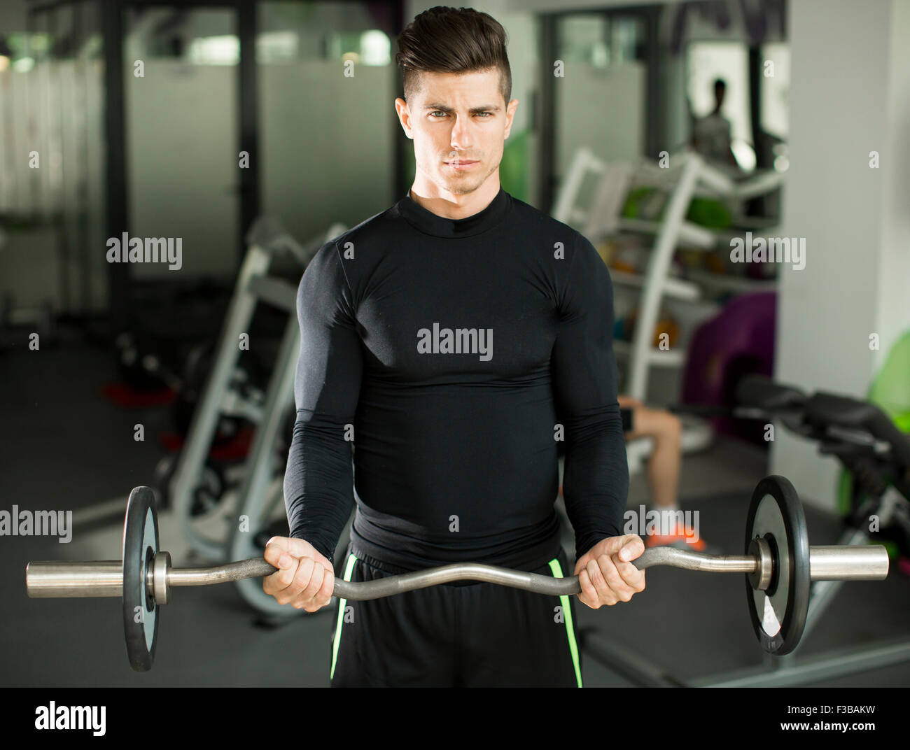 Young man training in the gym Stock Photo - Alamy