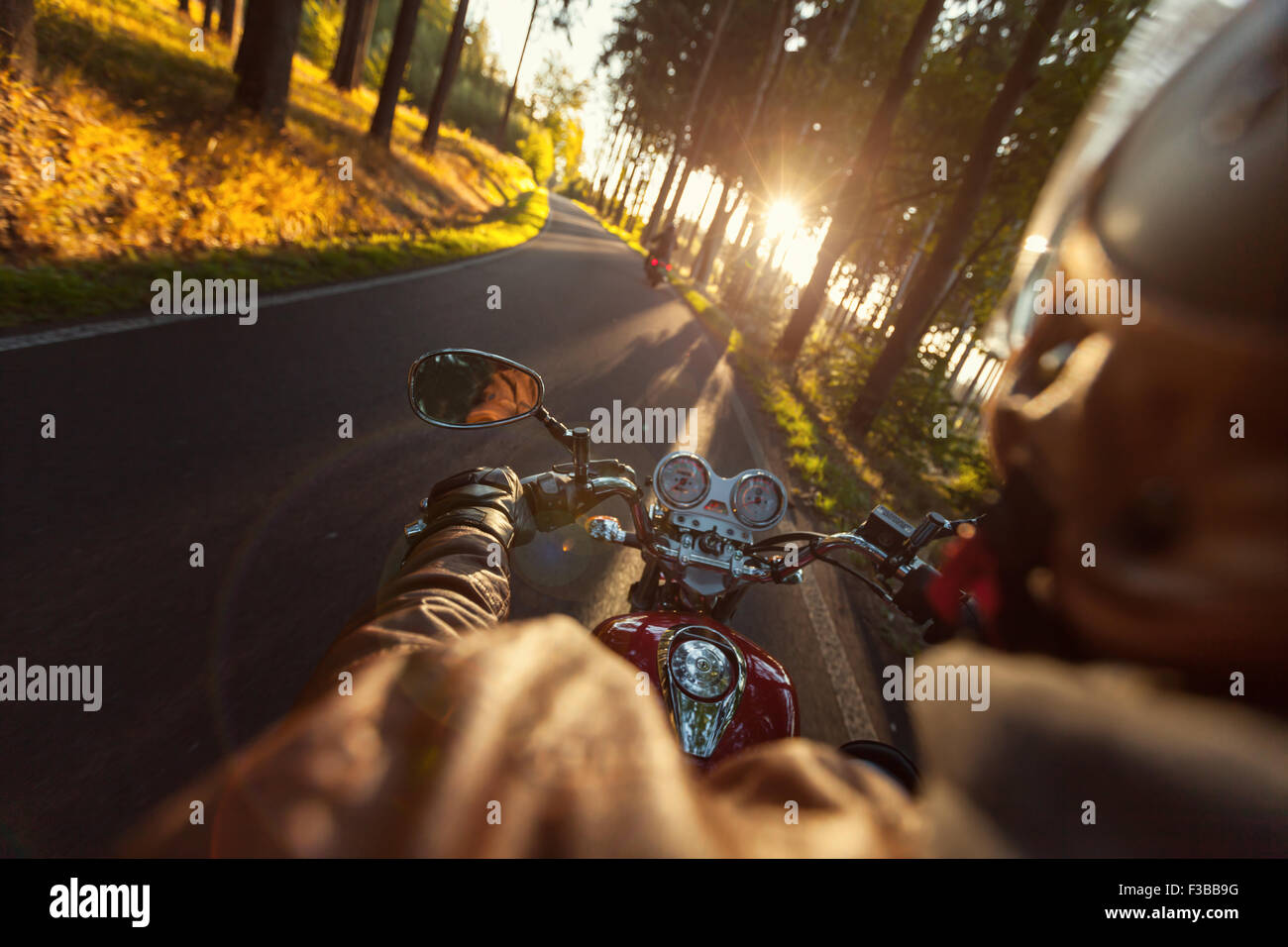 Biker riding motorcycle in sunny morning Stock Photo - Alamy
