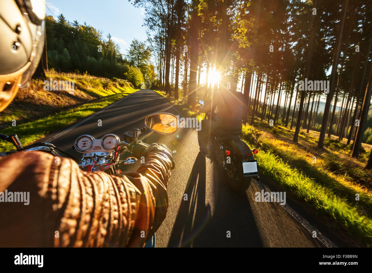 Biker riding motorcycle in sunny morning Stock Photo - Alamy