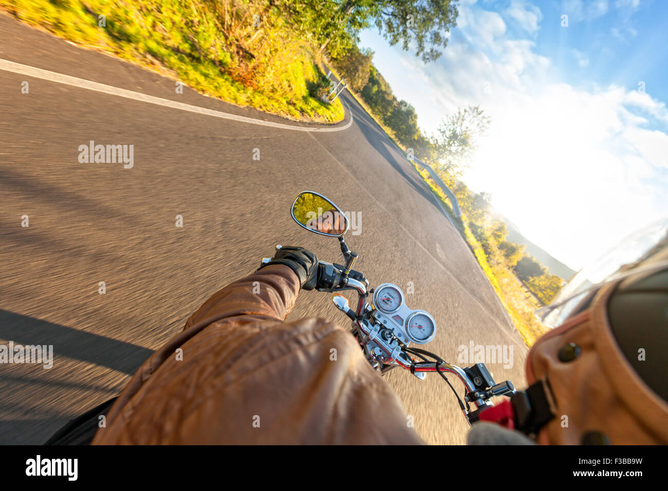 Biker riding motorcycle in sunny morning Stock Photo - Alamy