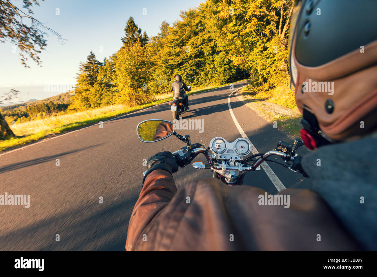 Biker riding motorcycle in sunny morning Stock Photo - Alamy
