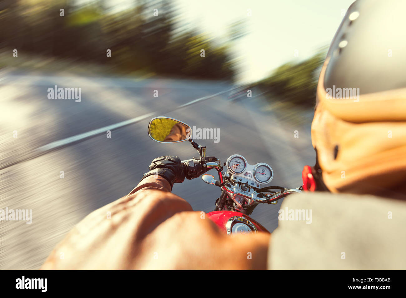 Biker riding motorcycle in sunny morning Stock Photo - Alamy