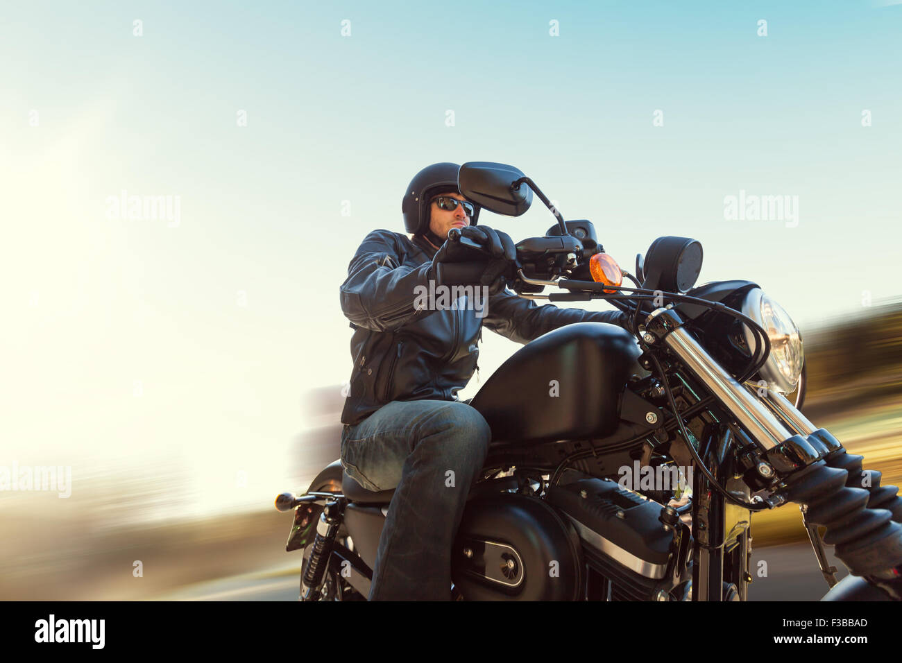 A young man riding a chopper on a road Stock Photo - Alamy
