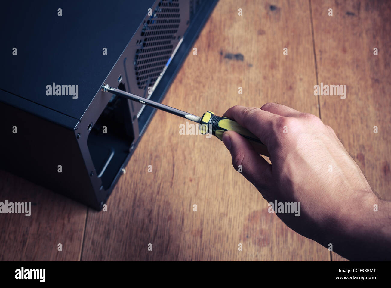 Technician with a screwdriver for fixing computers hi-res stock ...