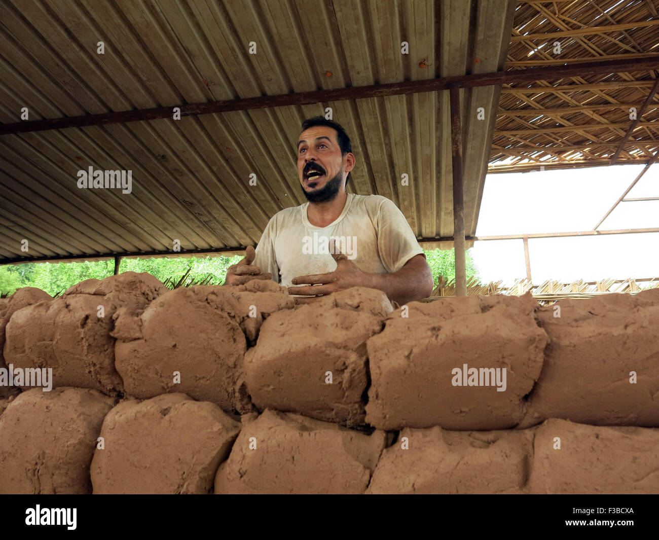 Baghdad, Iraq. 4th Oct, 2015. Abu Ibrahim makes pottery jars at his ...
