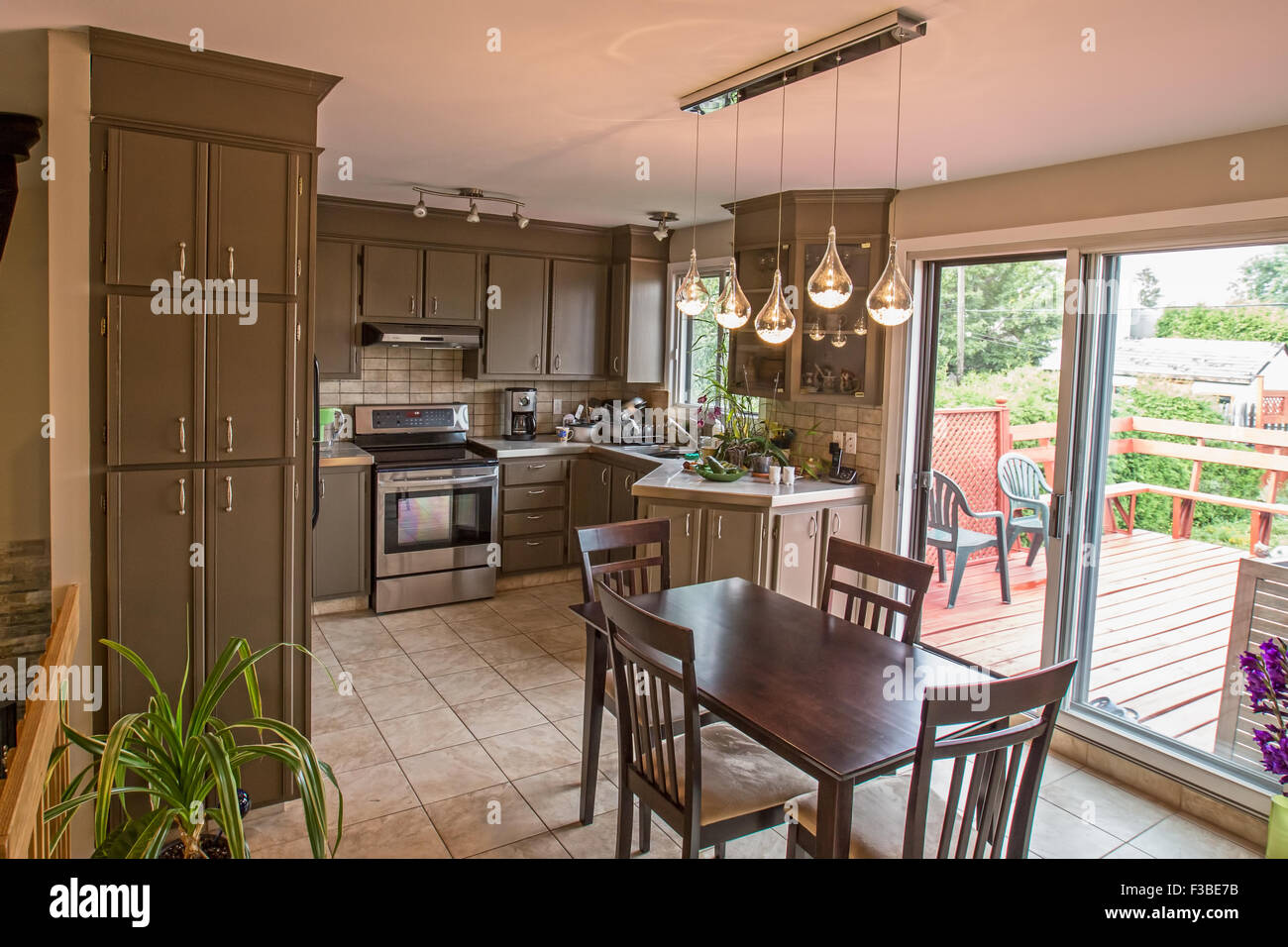Dining room with kitchen on the background Stock Photo - Alamy