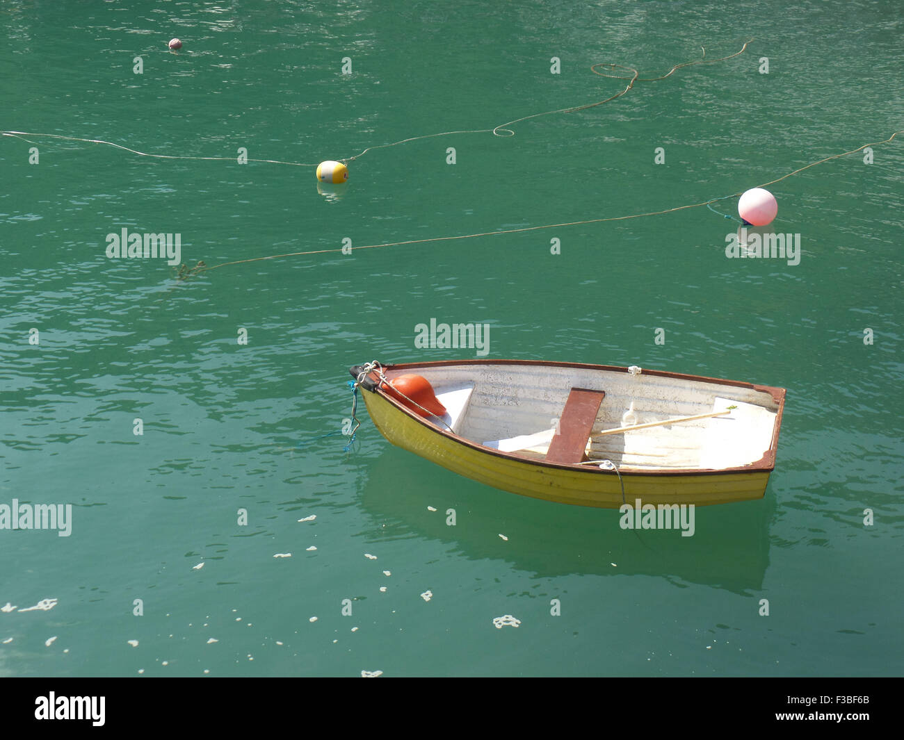 Rowing Boat bobbing on water Stock Photo - Alamy