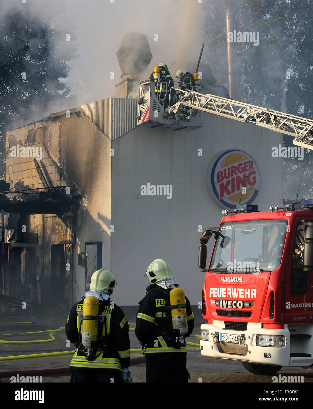 The fire service works to extinguish a burning fast food restaurant in ...