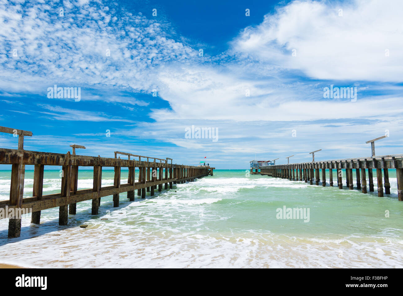 Long bridge on the beach with blue sky Stock Photo - Alamy