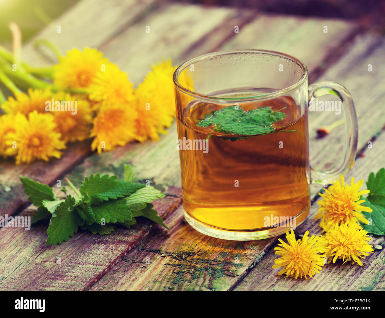 A cup of melissa herbal tea on a wooden table Stock Photo - Alamy
