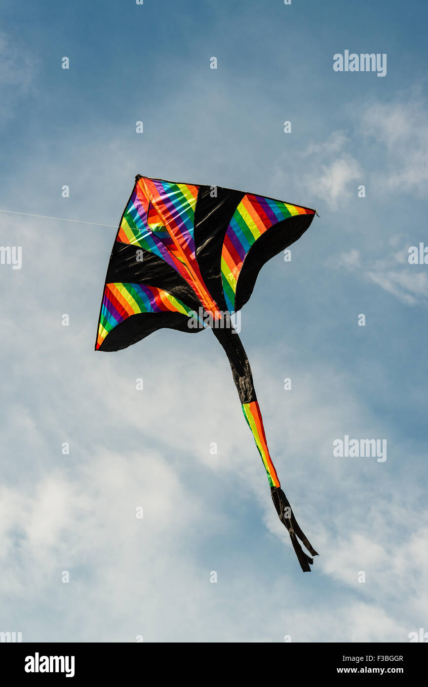 colorful kite flying in blue sky Stock Photo - Alamy